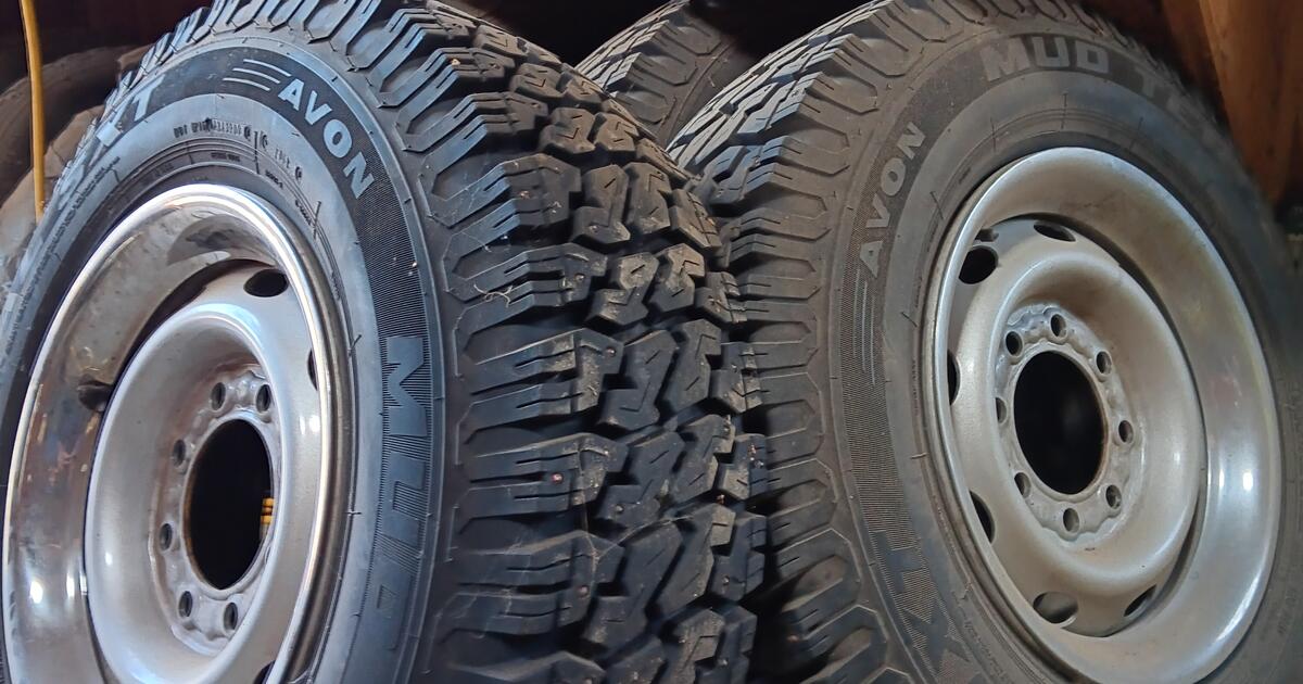 4 nearly new wheels/rims; must take attached nearly new studded tires ...