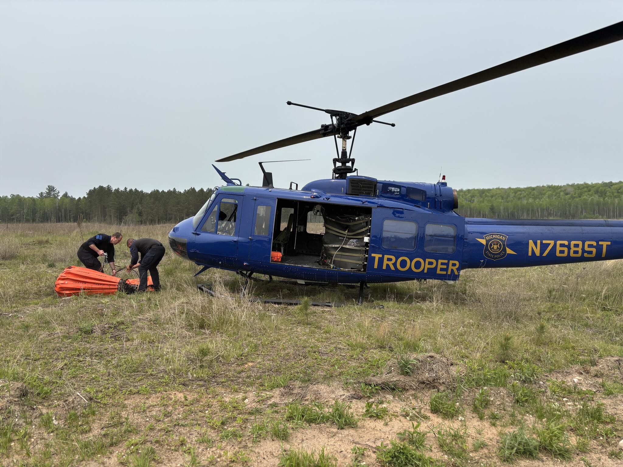 MSP helicopter and crew, call sign “Trooper 4” assisting the DNR with a fire near Iron Mountain ...