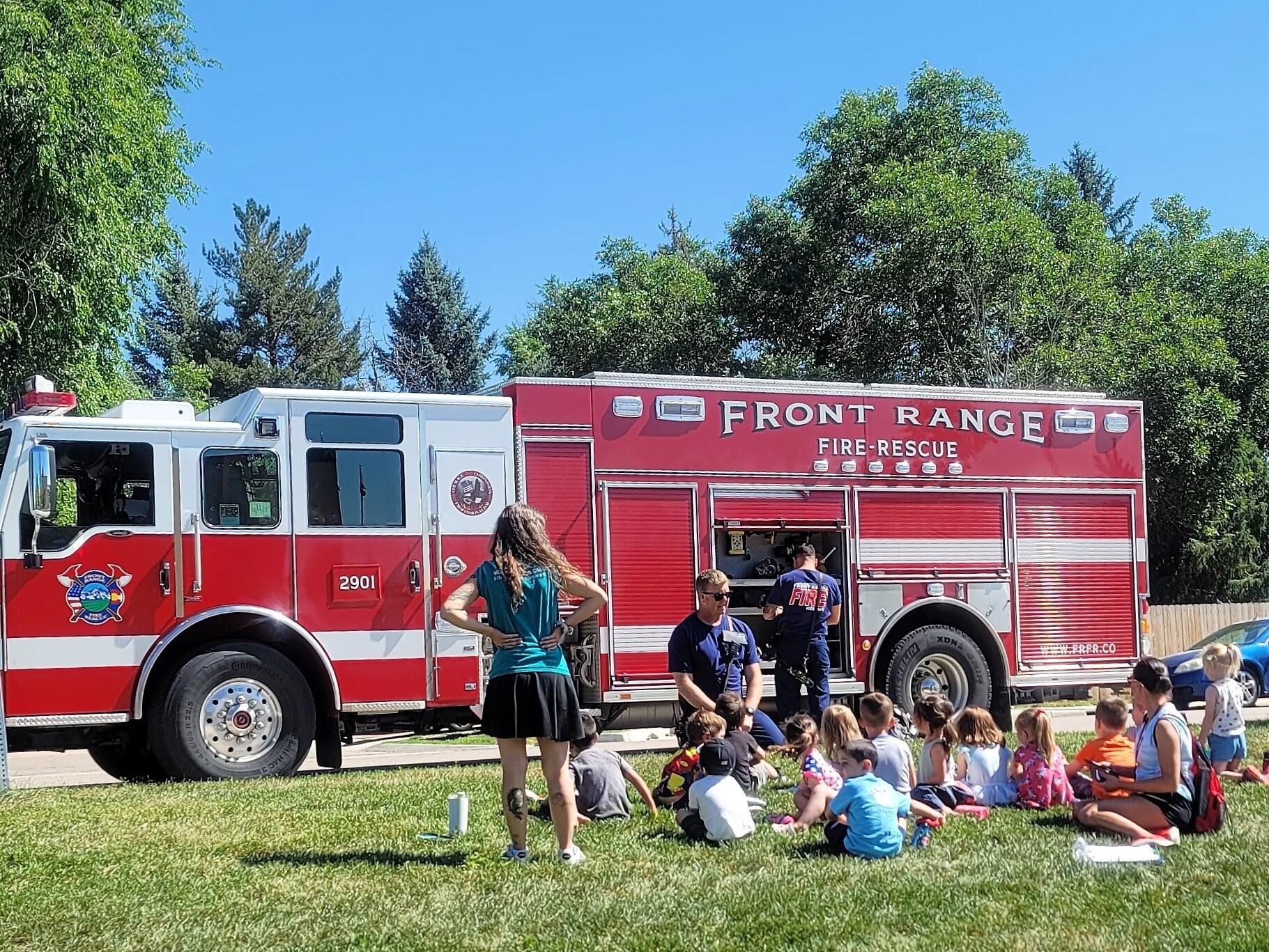 Firefighters put on all of their gear so kids can see what they look ...
